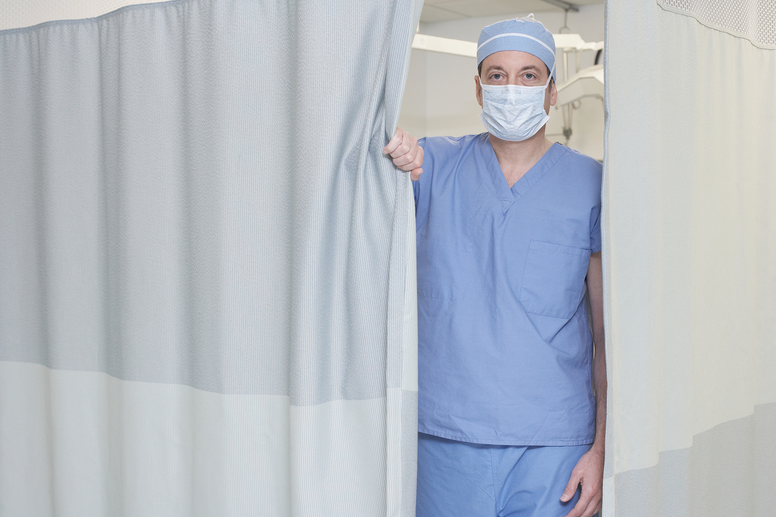 Male doctor opening privacy curtain - My CMS